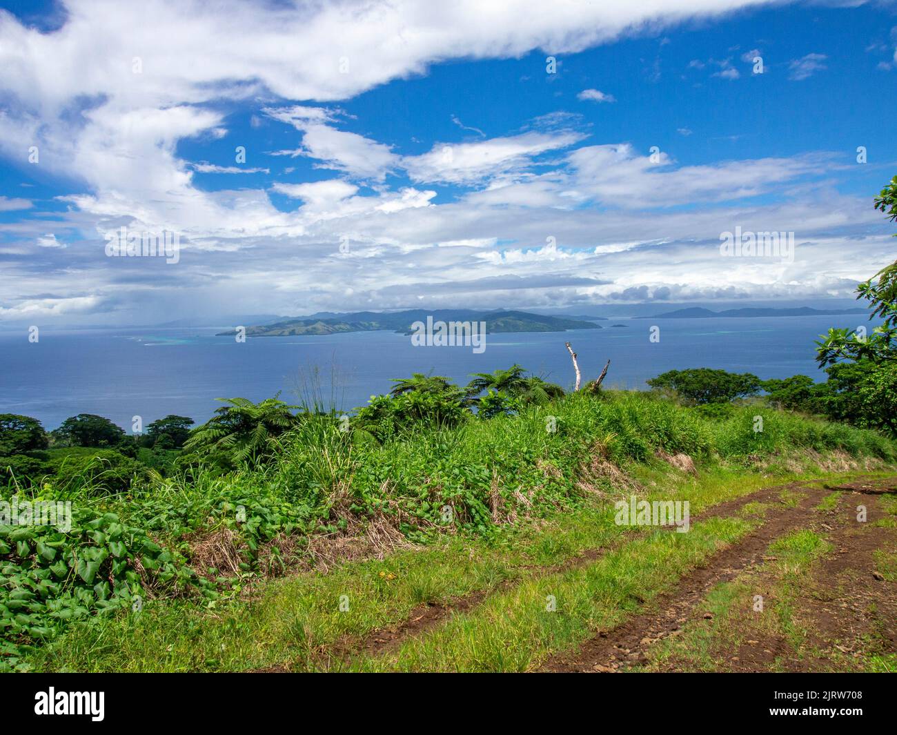 Cliffside overlook from a lush, tropical viewpoint shows the beautiful ...