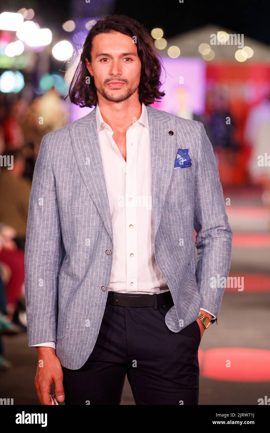 Models walk a fashion runway wearing brands from local and ...