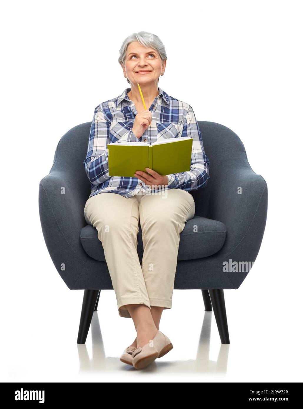 smiling senior woman in armchair writing to diary Stock Photo - Alamy