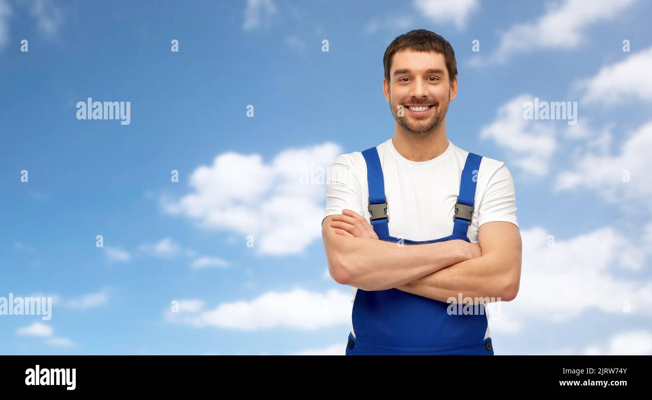 happy smiling male worker or builder in overall Stock Photo - Alamy
