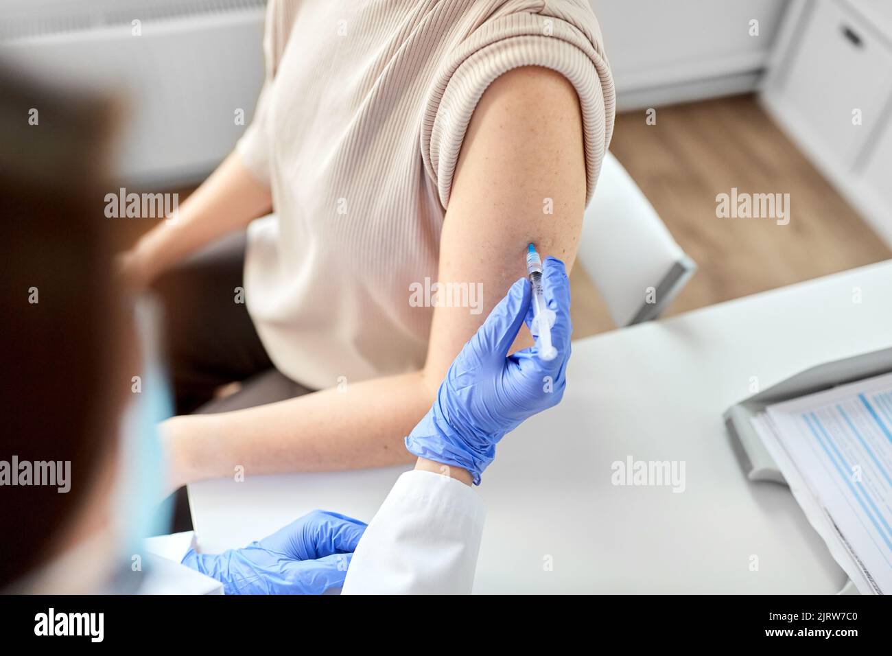 female doctor with syringe vaccinating patient Stock Photo - Alamy