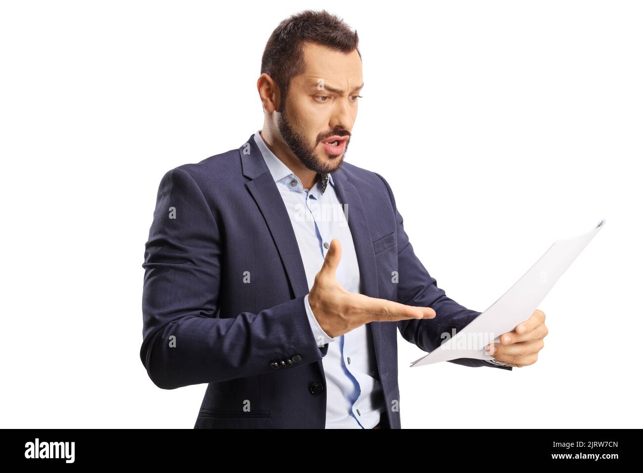 Angry young man looking at a paper document isolated on white ...