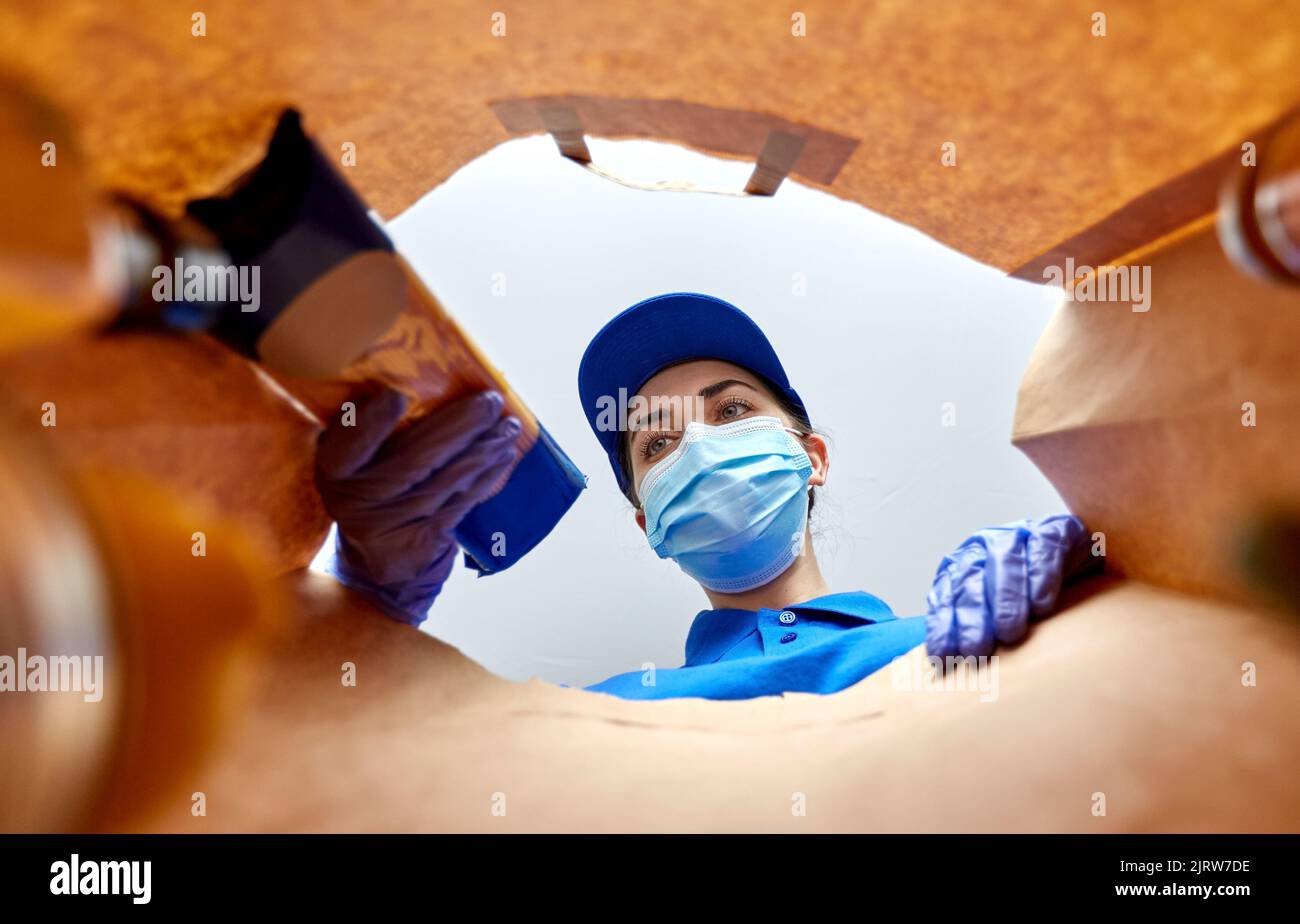 delivery girl in gloves and mask with food in bag Stock Photo - Alamy