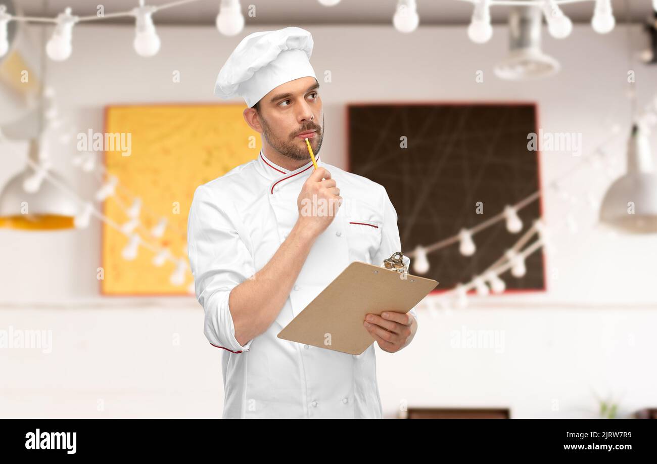 thinking male chef with clipboard at restaurant Stock Photo - Alamy