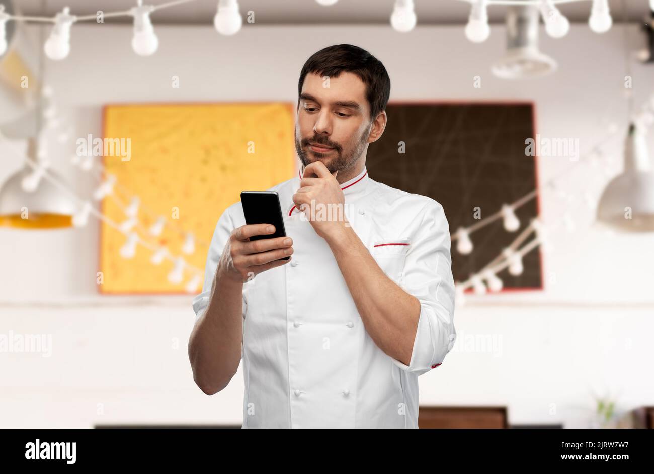 thinking male chef with smartphone Stock Photo - Alamy