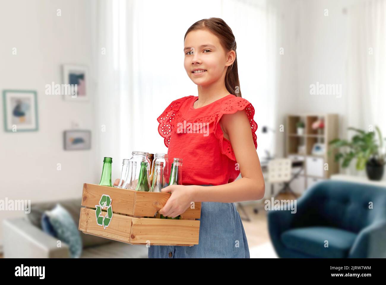 smiling girl sorting glass waste at home Stock Photo - Alamy