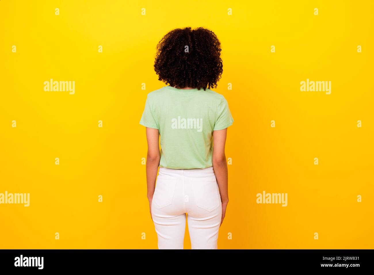 Photo of adorable slender girl dressed green t-shirt standing back ...