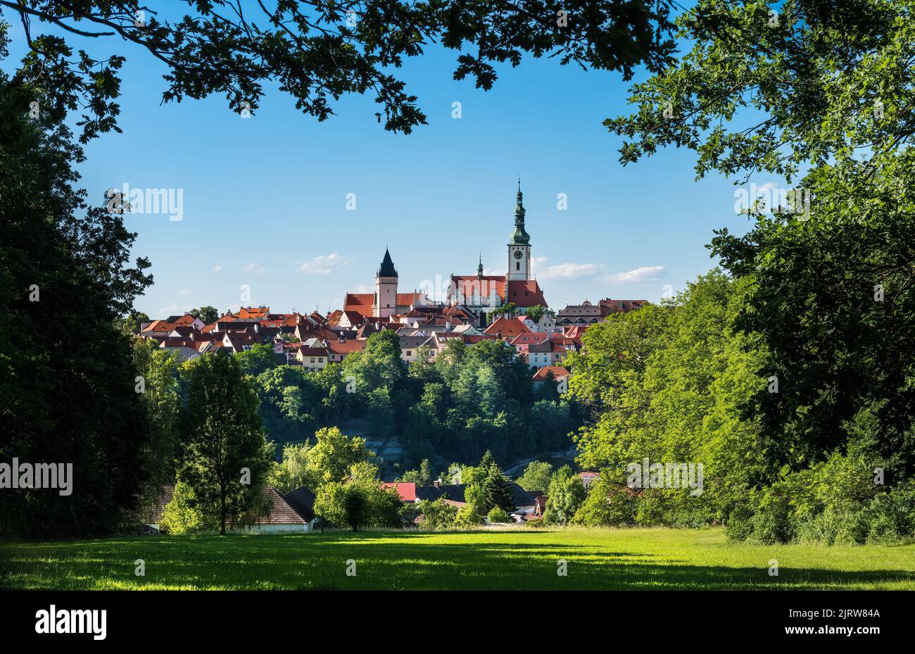 Beautiful look to scenic Tabor old town framed by green tree branches ...