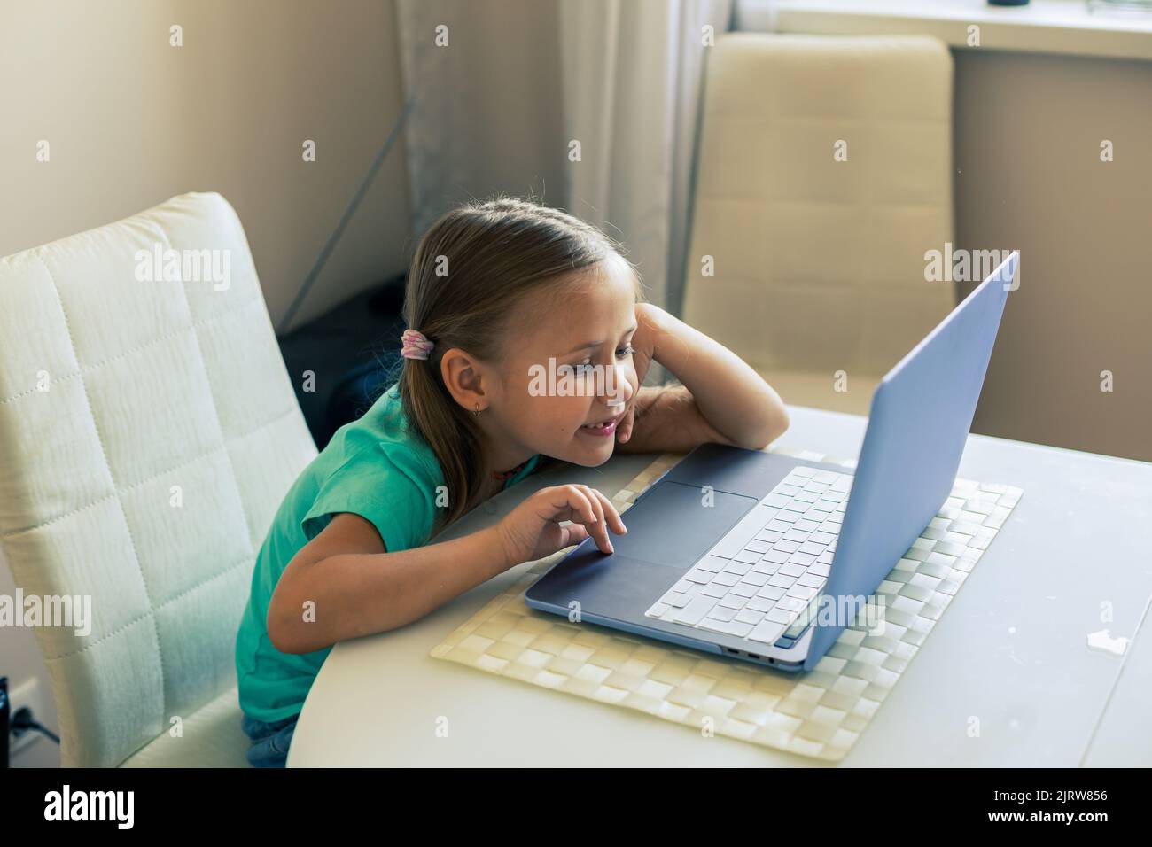 Little cute girl uses laptop to have video call Stock Photo - Alamy