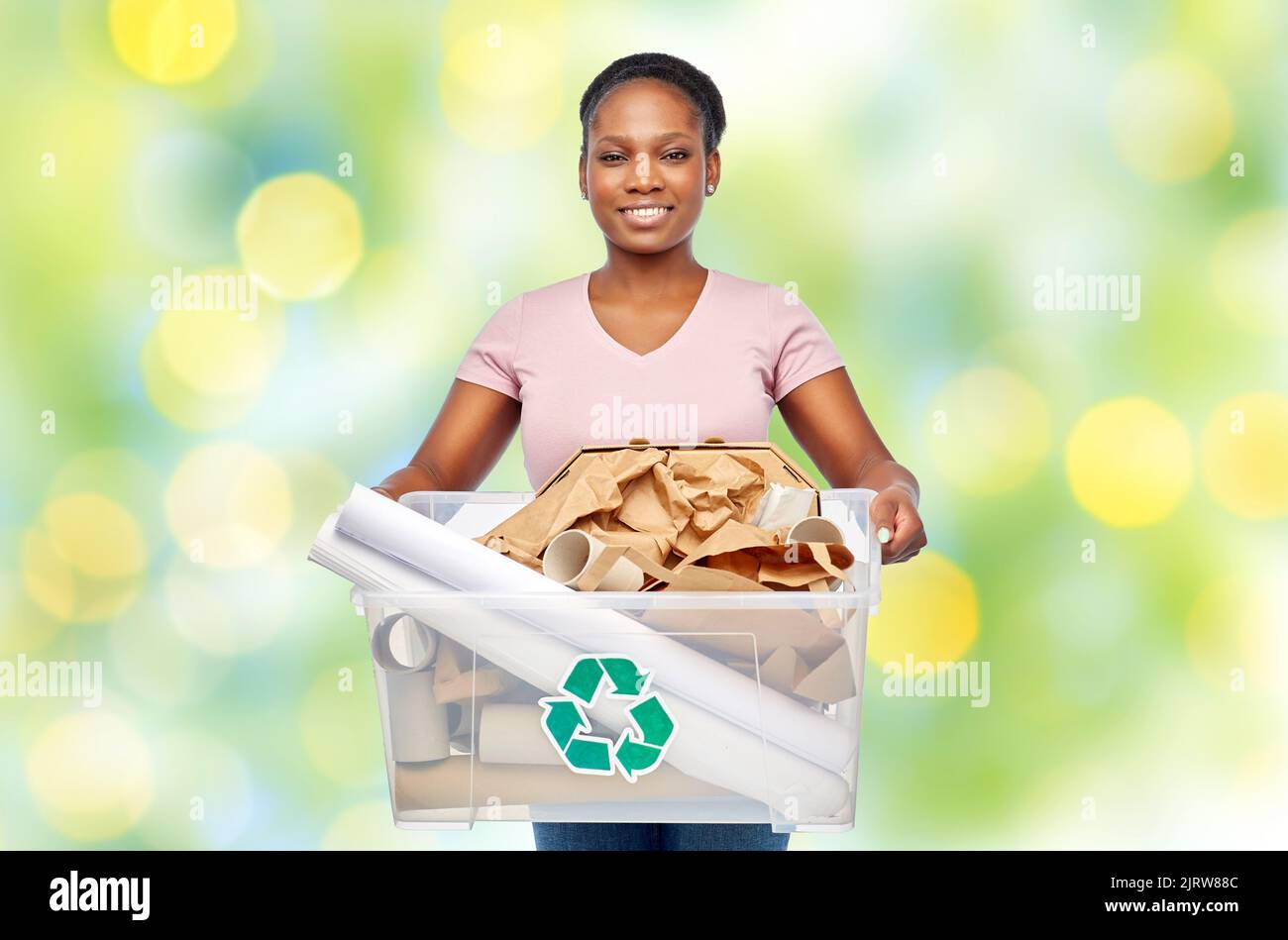happy african american woman sorting paper waste Stock Photo - Alamy