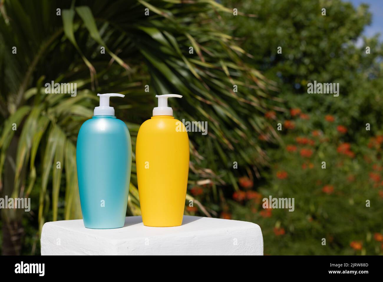 Sunscreen bottles on palm leaves background. Mockup Stock Photo - Alamy