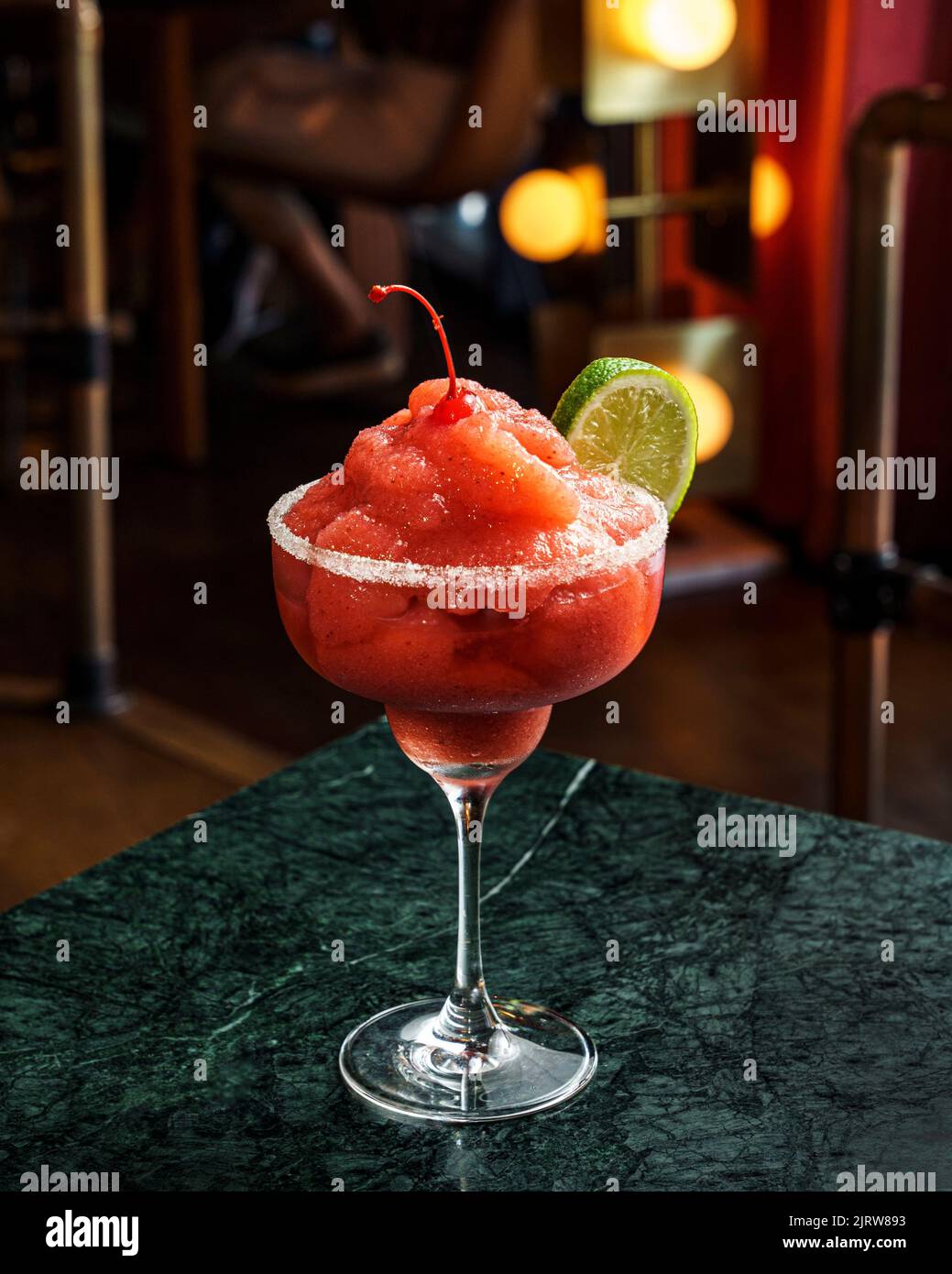 A glass of strawberry frappe drink with lime slice Stock Photo - Alamy