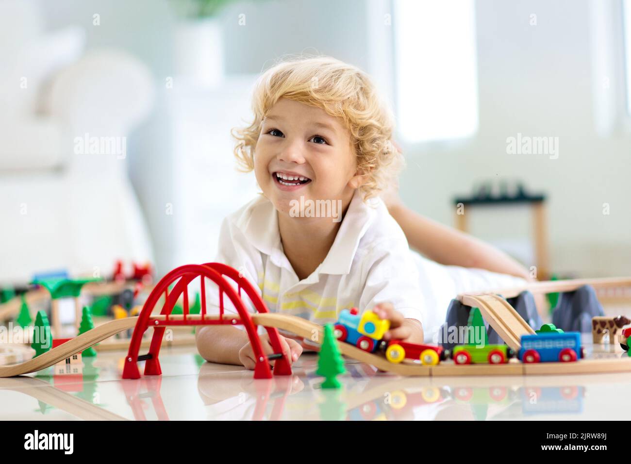 Kids play with wooden railway. Child with toy train. Educational toys ...