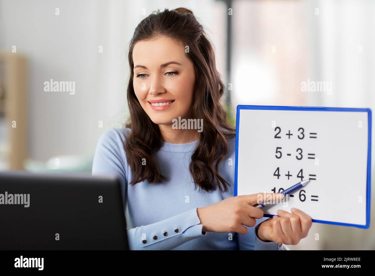 math teacher having online class at home Stock Photo - Alamy