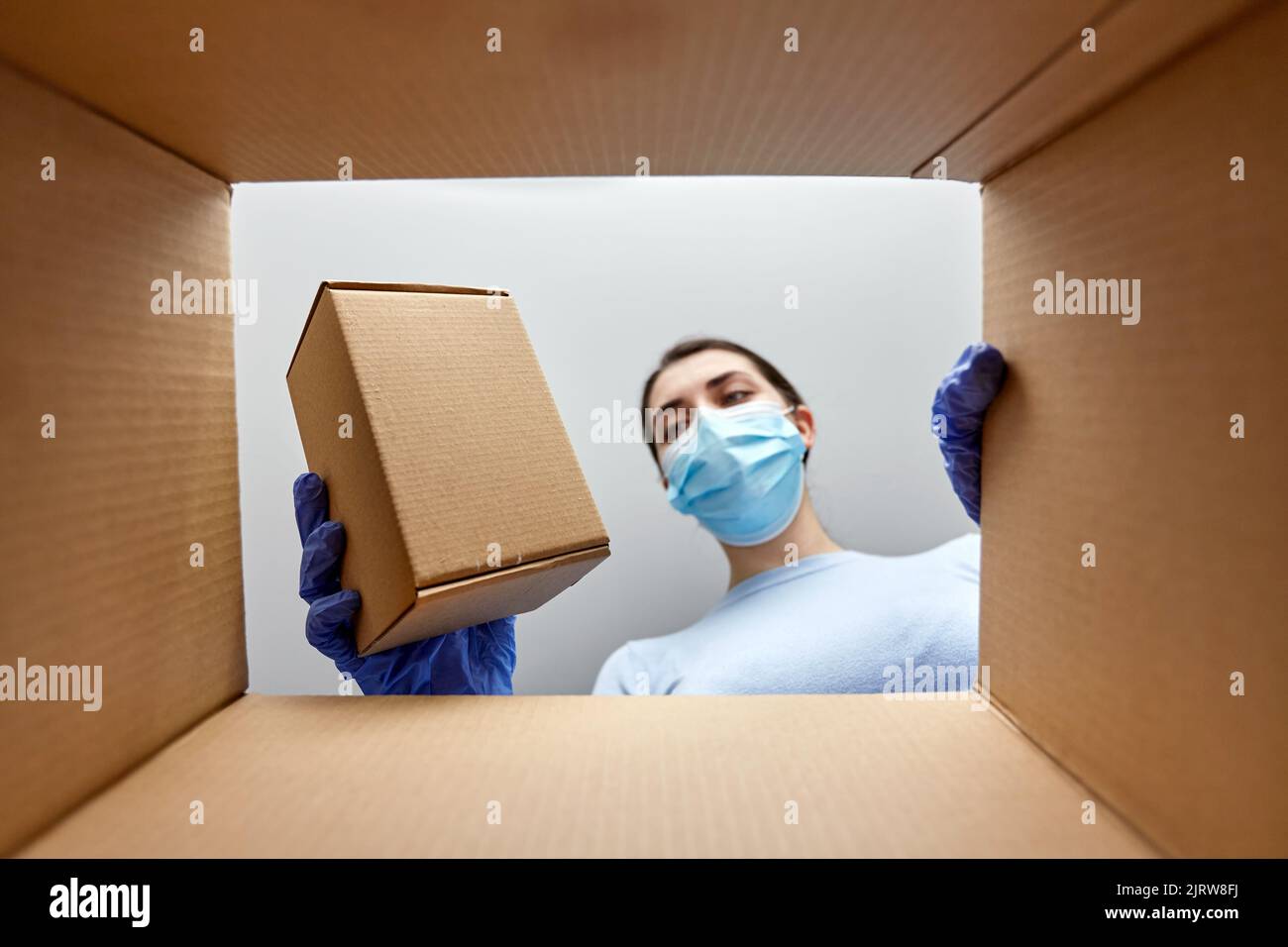Woman unpacking parcel box hi-res stock photography and images - Alamy