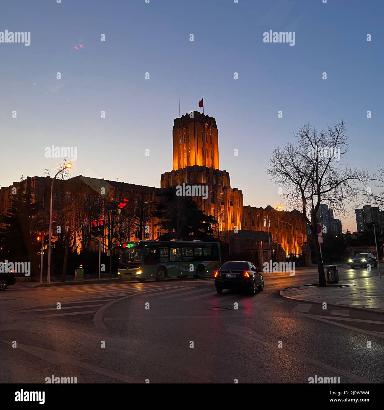 An old building on the side of a street in Dalian, China during dusk ...