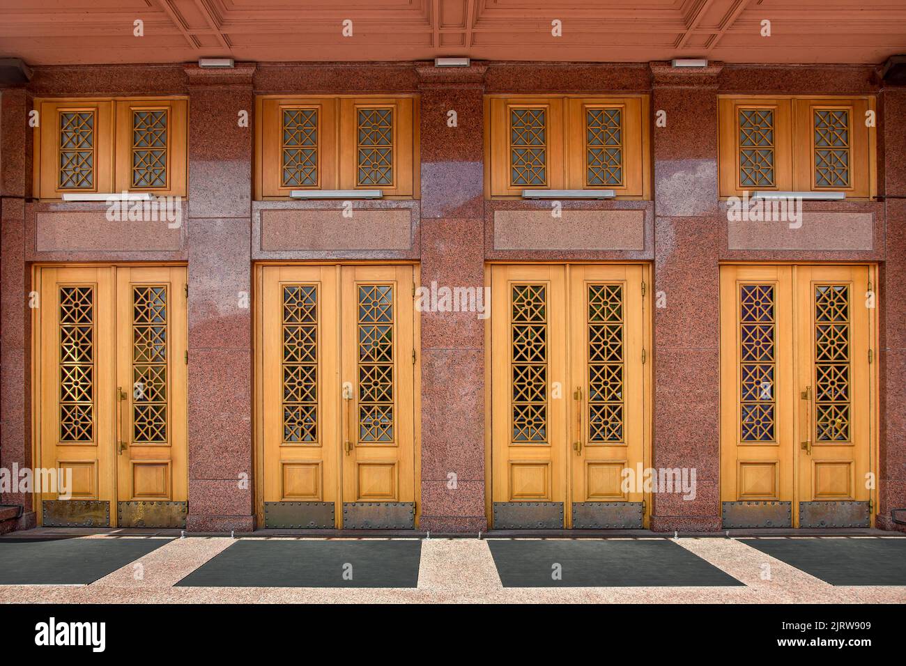 facade of old building is lined with marble entrance wooden doors and ...