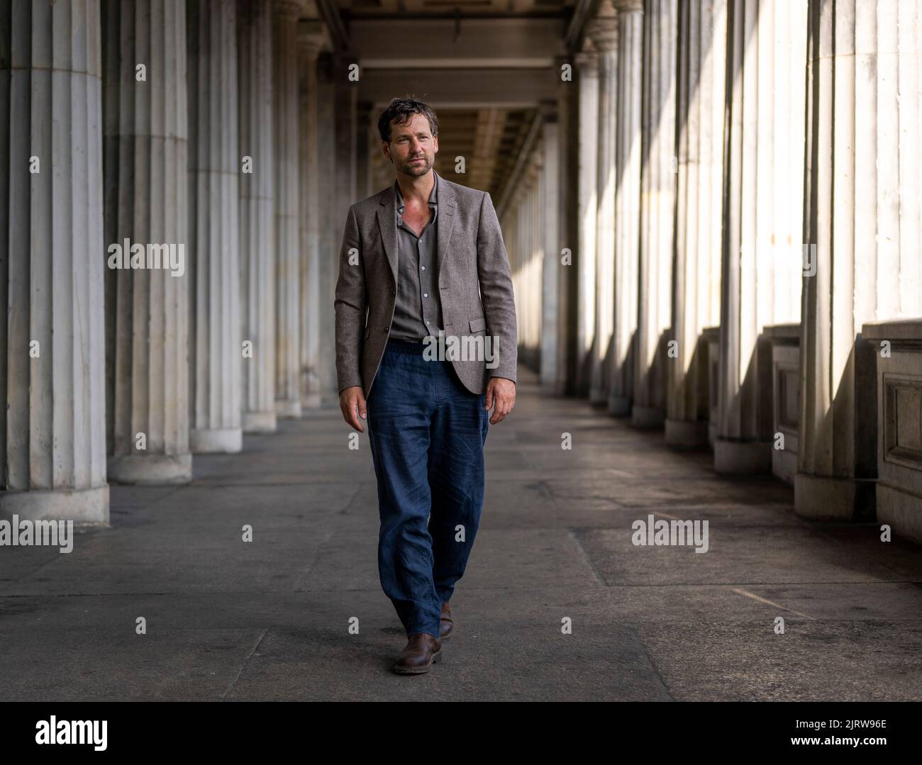 Berlin, Germany. 26th Aug, 2022. Actor Florian Stetter walks down a ...