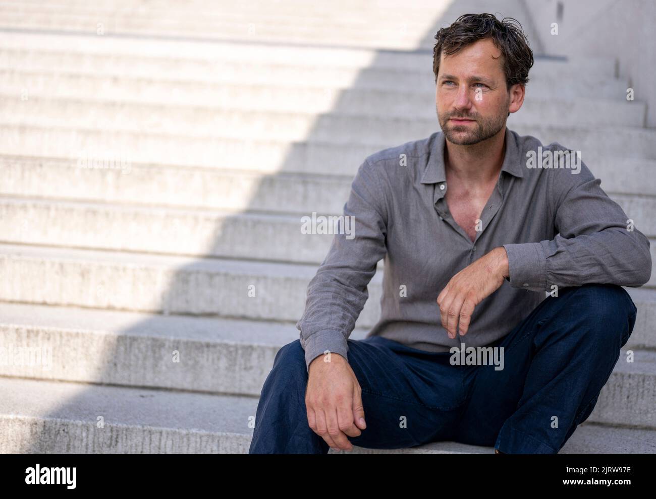 Berlin, Germany. 26th Aug, 2022. Actor Florian Stetter sits on a ...