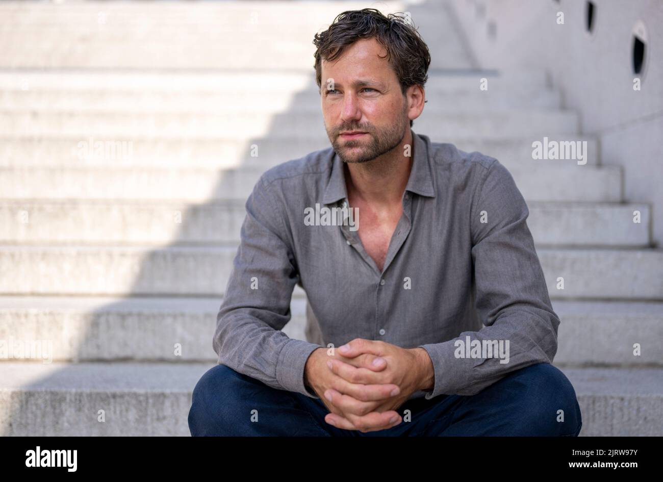 Berlin, Germany. 26th Aug, 2022. Actor Florian Stetter sits on a ...