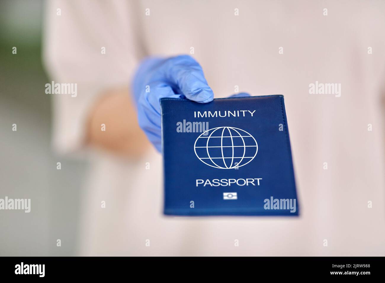 woman in glove holding immunity passport Stock Photo - Alamy
