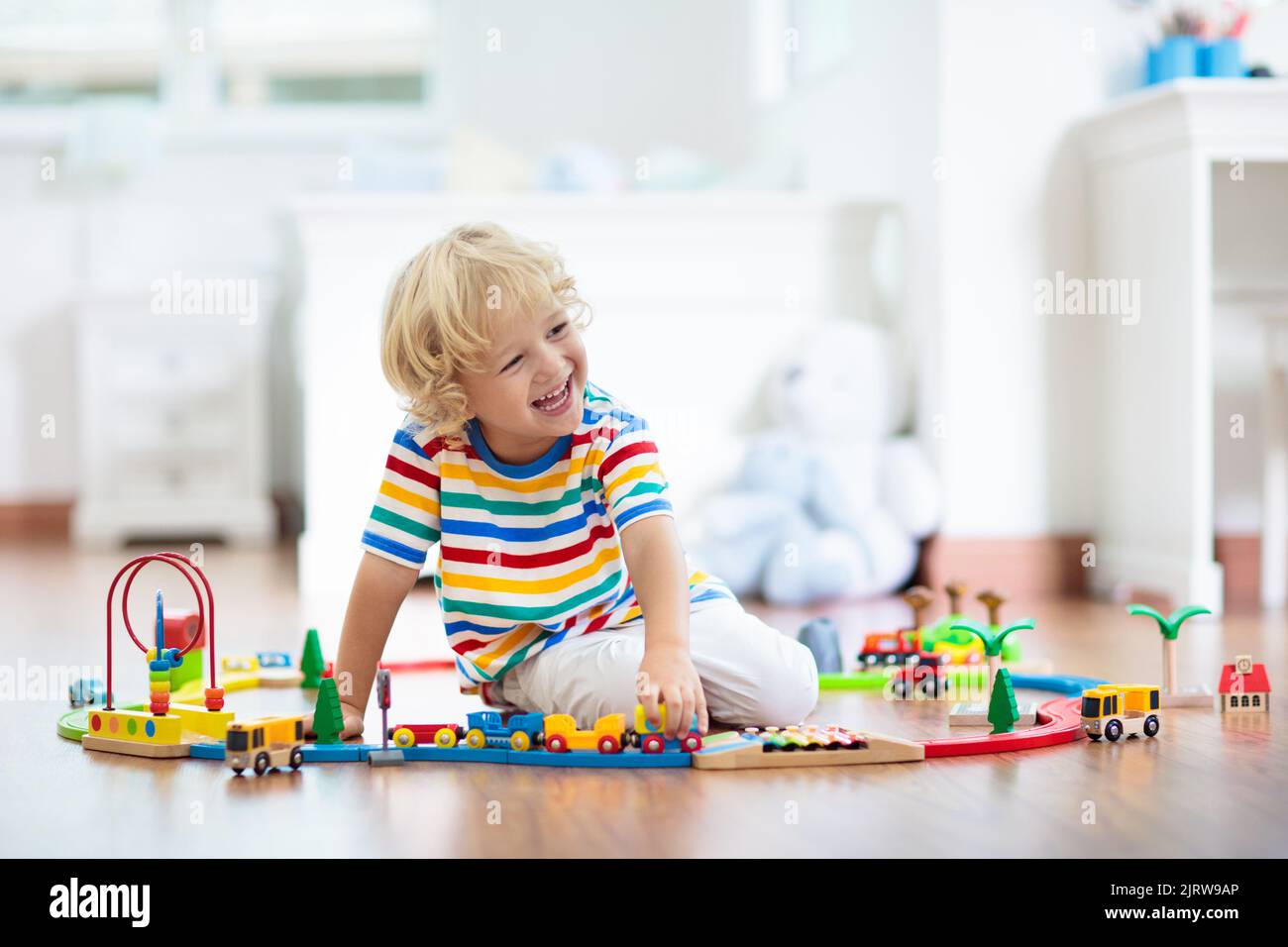 Kids play with wooden railway. Child with toy train. Educational toys ...