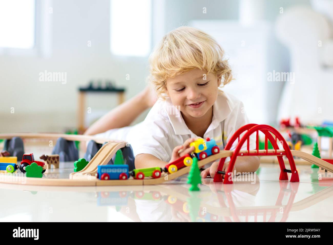 Kids play with wooden railway. Child with toy train. Educational toys ...