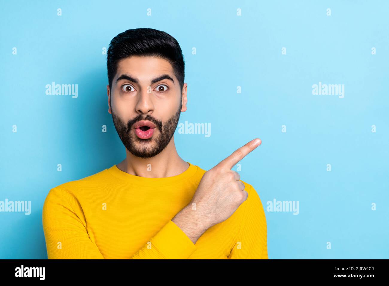 Photo of funny impressed guy dressed yellow pullover pointing finger ...