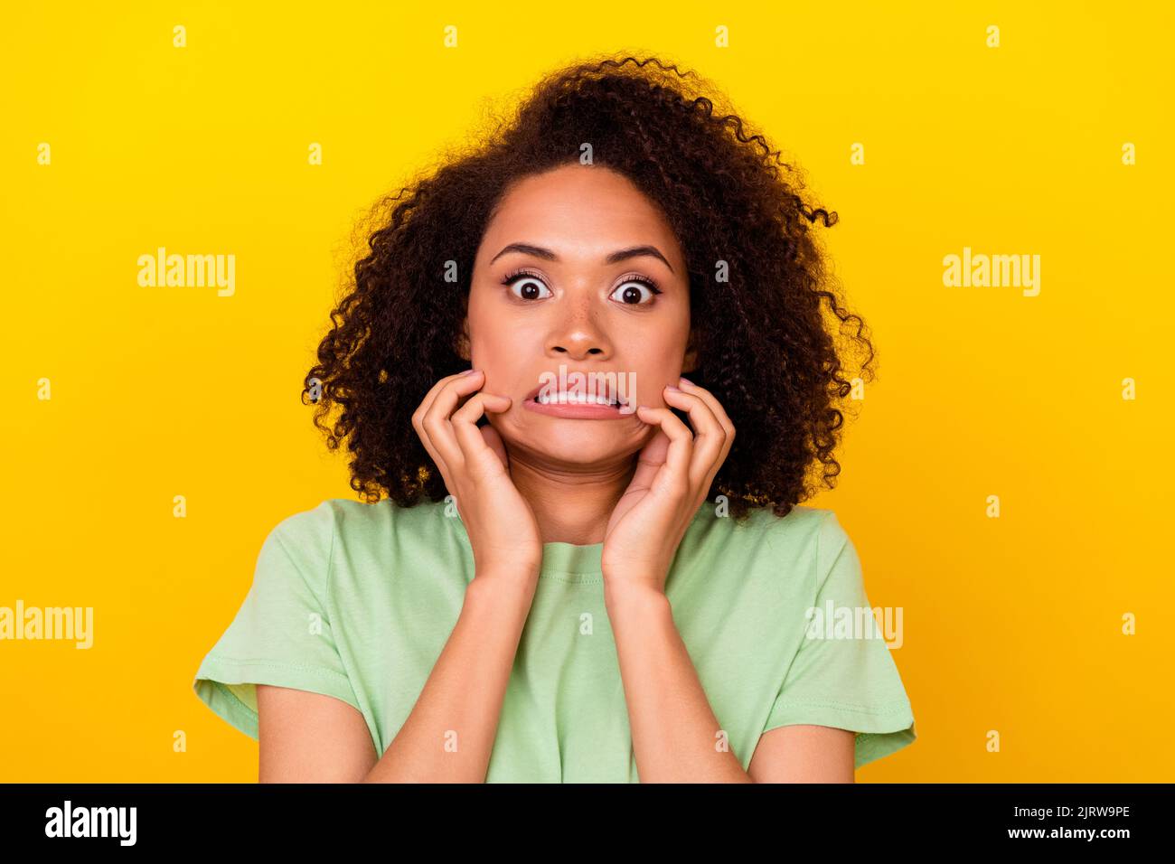 Photo Of Impressed Scared Girl Dressed Green T Shirt Arms Cheeks Big