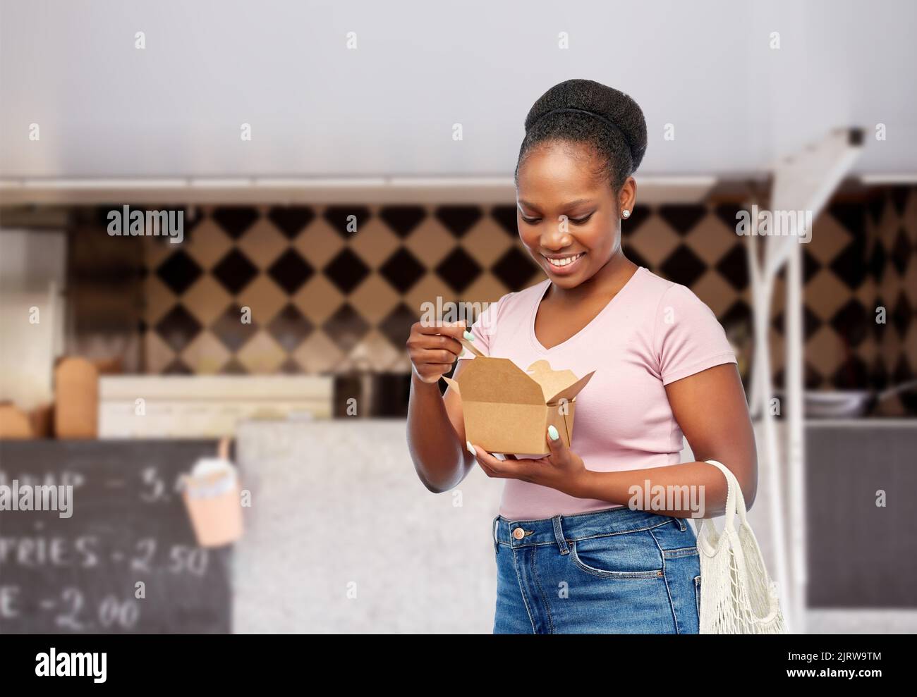 happy woman eating wok over food truck Stock Photo - Alamy