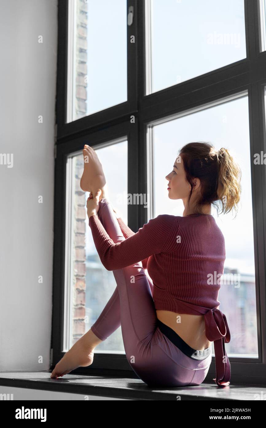 Woman relaxing on windowsill hi-res stock photography and images - Alamy