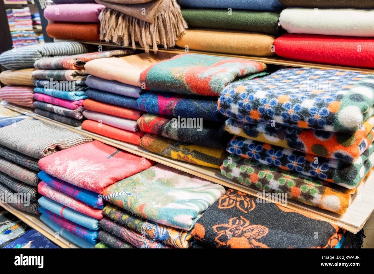 Colorful assortment of embroidered fashion textile fabrics in close up ...