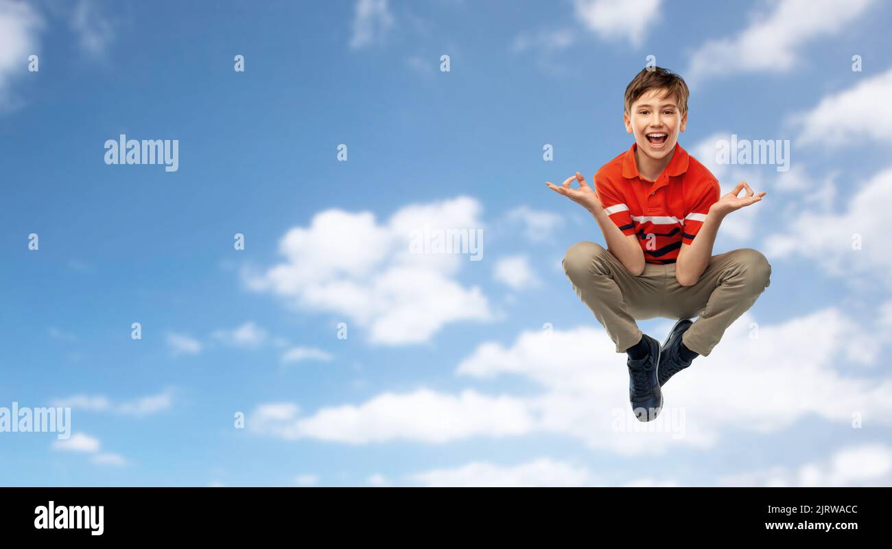 happy young boy flying in yoga pose over sky Stock Photo - Alamy