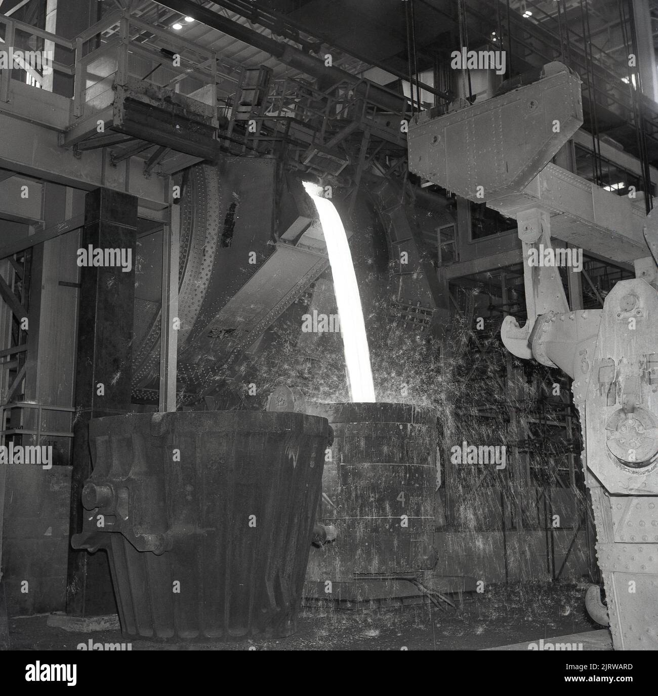 1950s, historical, steel making, melted molten iron ore being poured ...