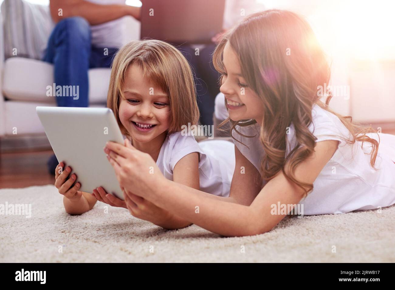 happy little girls with tablet pc computer at home Stock Photo - Alamy