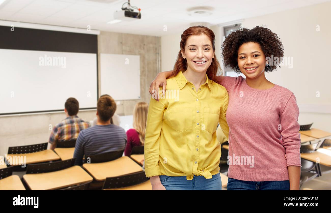 happy smiling student women hugging at university Stock Photo - Alamy