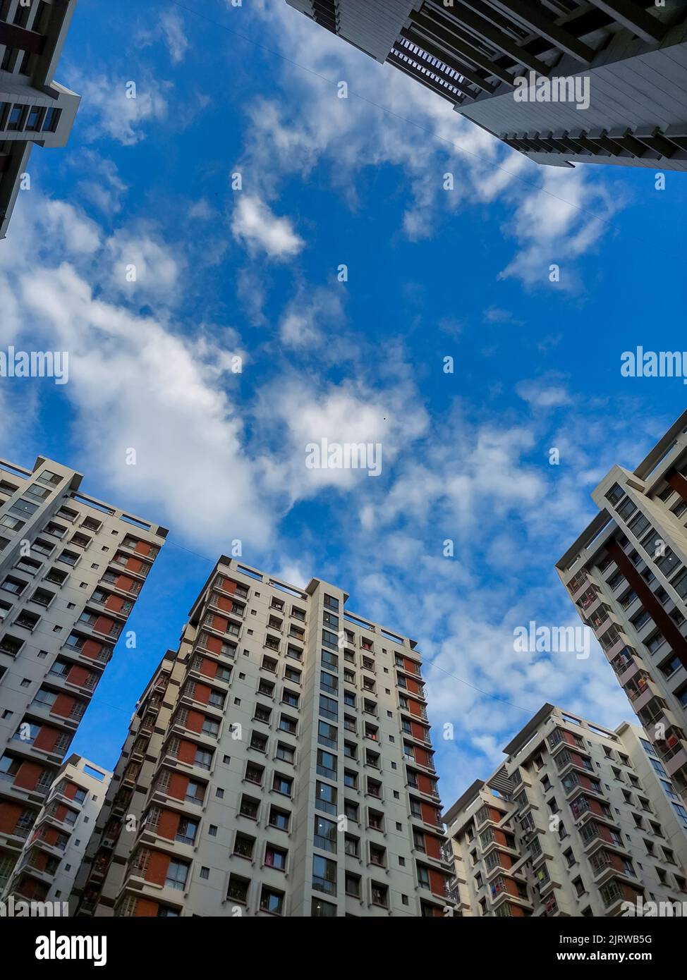 Cloudy blue sky in the gap of high raise building Stock Photo - Alamy