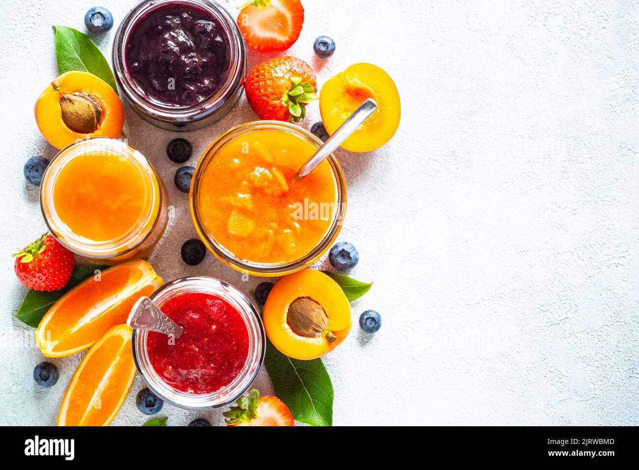 Homemade jam in glass jars at white table Stock Photo - Alamy