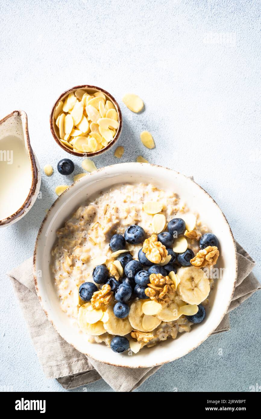 Oatmeal porrige in craft bowl at white background Stock Photo - Alamy