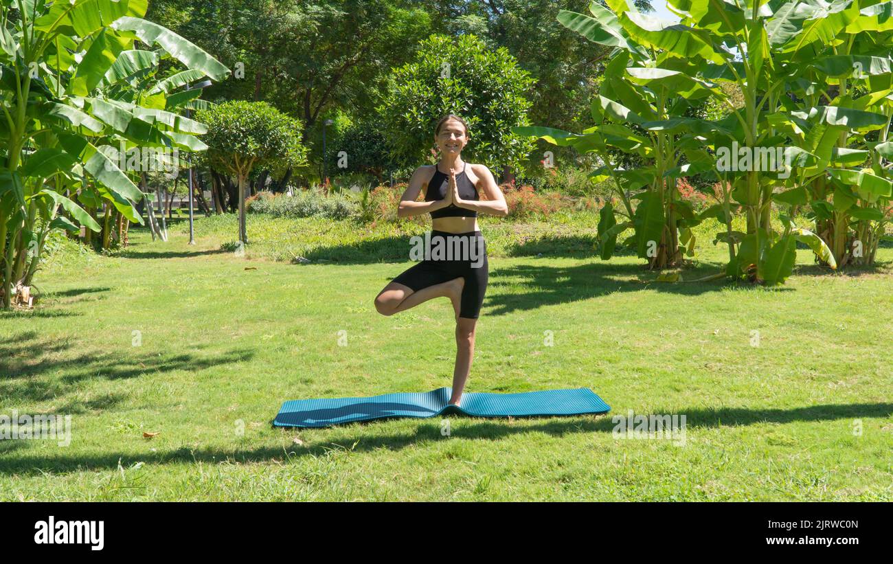Yoga poses, balance on one leg, a woman doing yoga in nature Stock ...