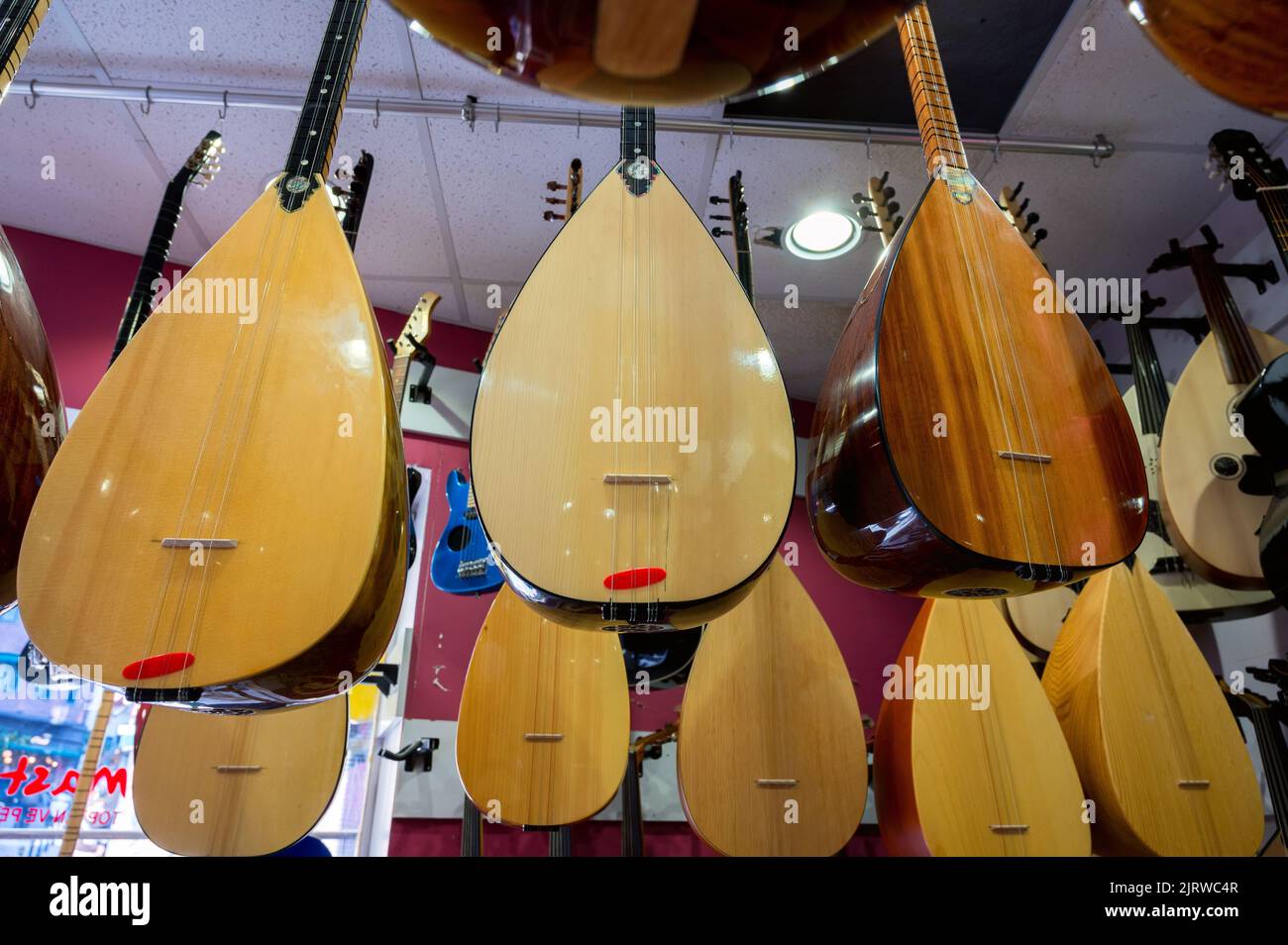 Istanbul, Turkey 2022. Rows of Turkish ethnic string instruments saz and baglama at a store on ...