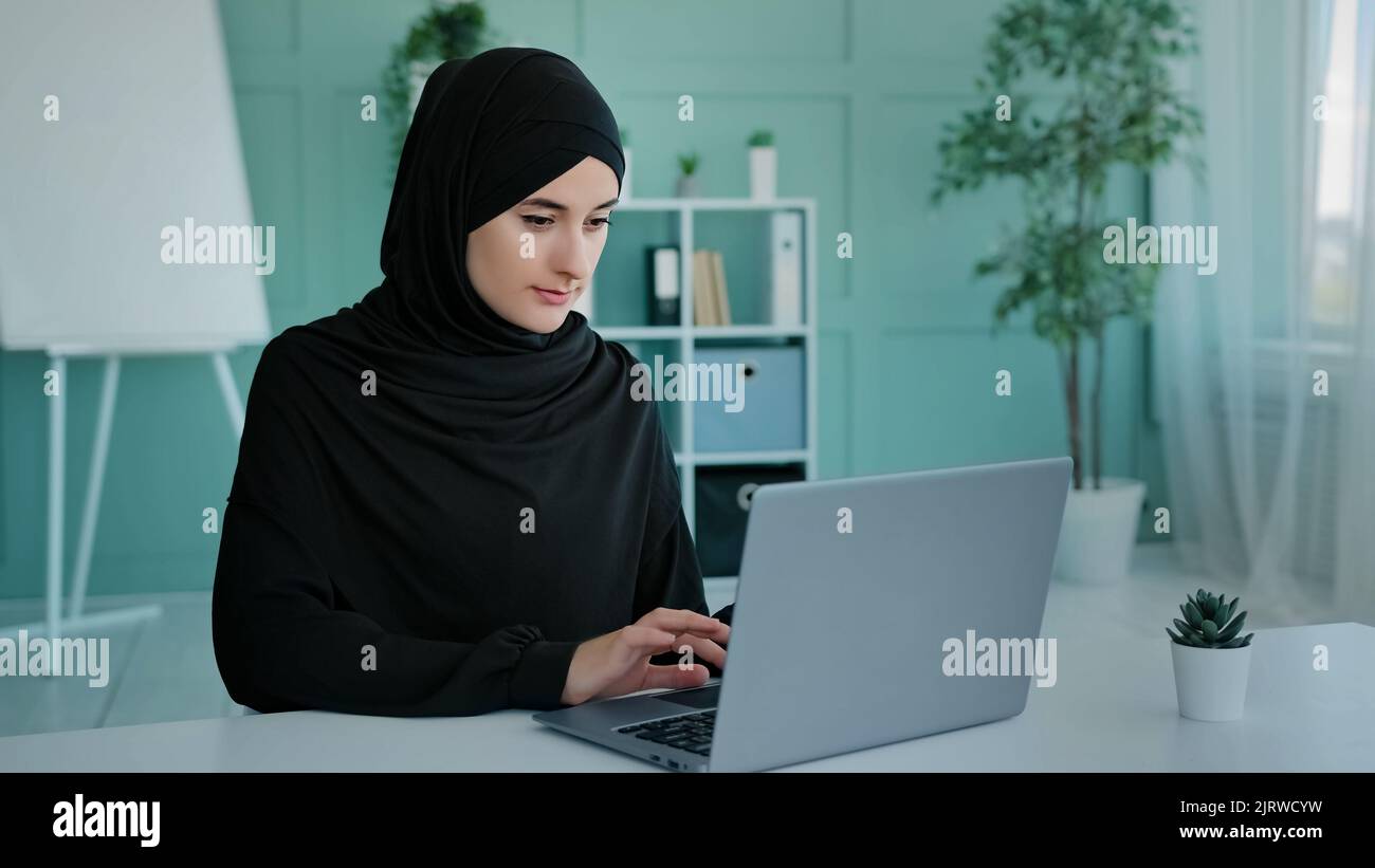 Busy Islam businesswoman in black hijab freelancer Islamic Arabian girl ...