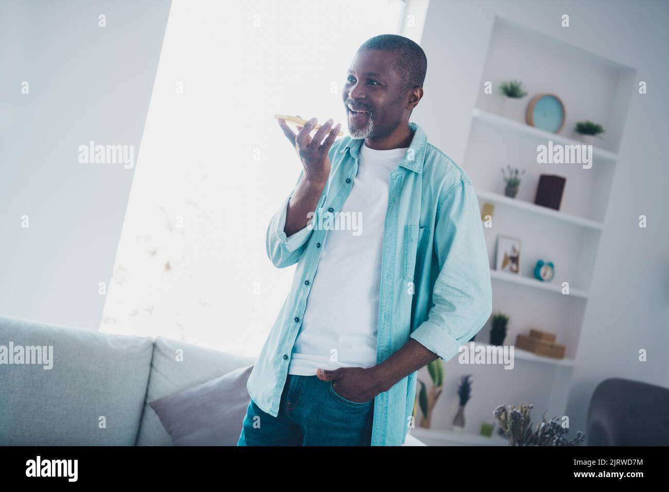 Photo of positive aged man recording voice message use speaker phone ...