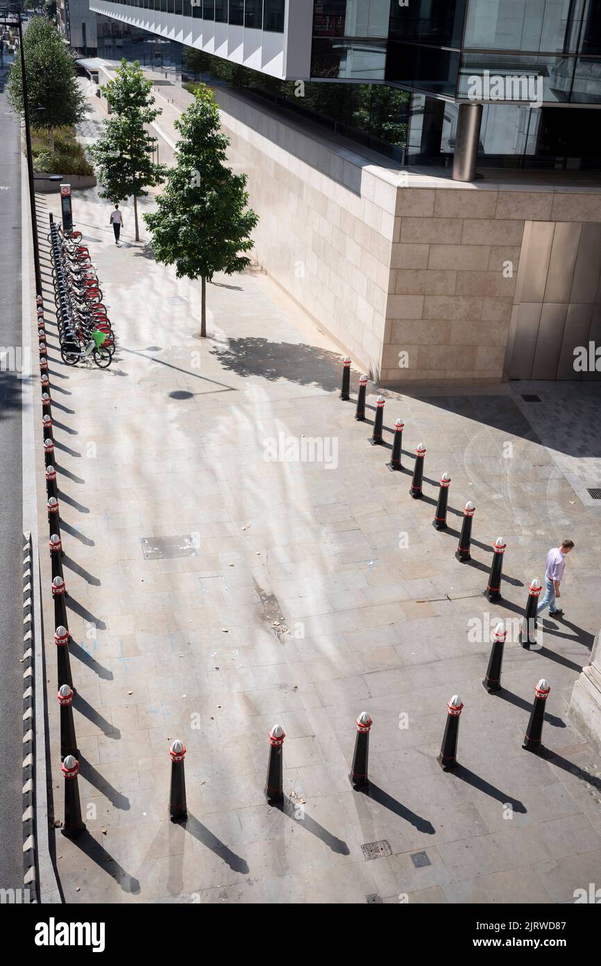 An aerial view of pedestrians walking along the pavement and passing ...