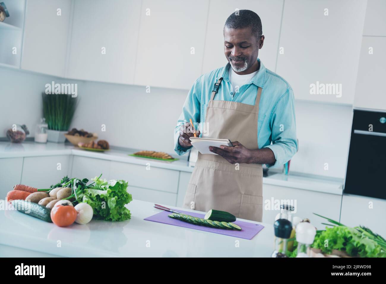 Photo of cheerful pretty age man wear apron inventing new cooking ...