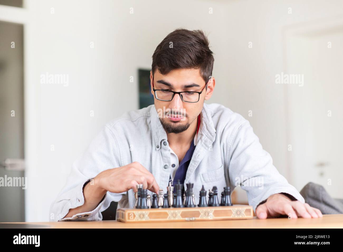 Young man and chess hi-res stock photography and images - Alamy