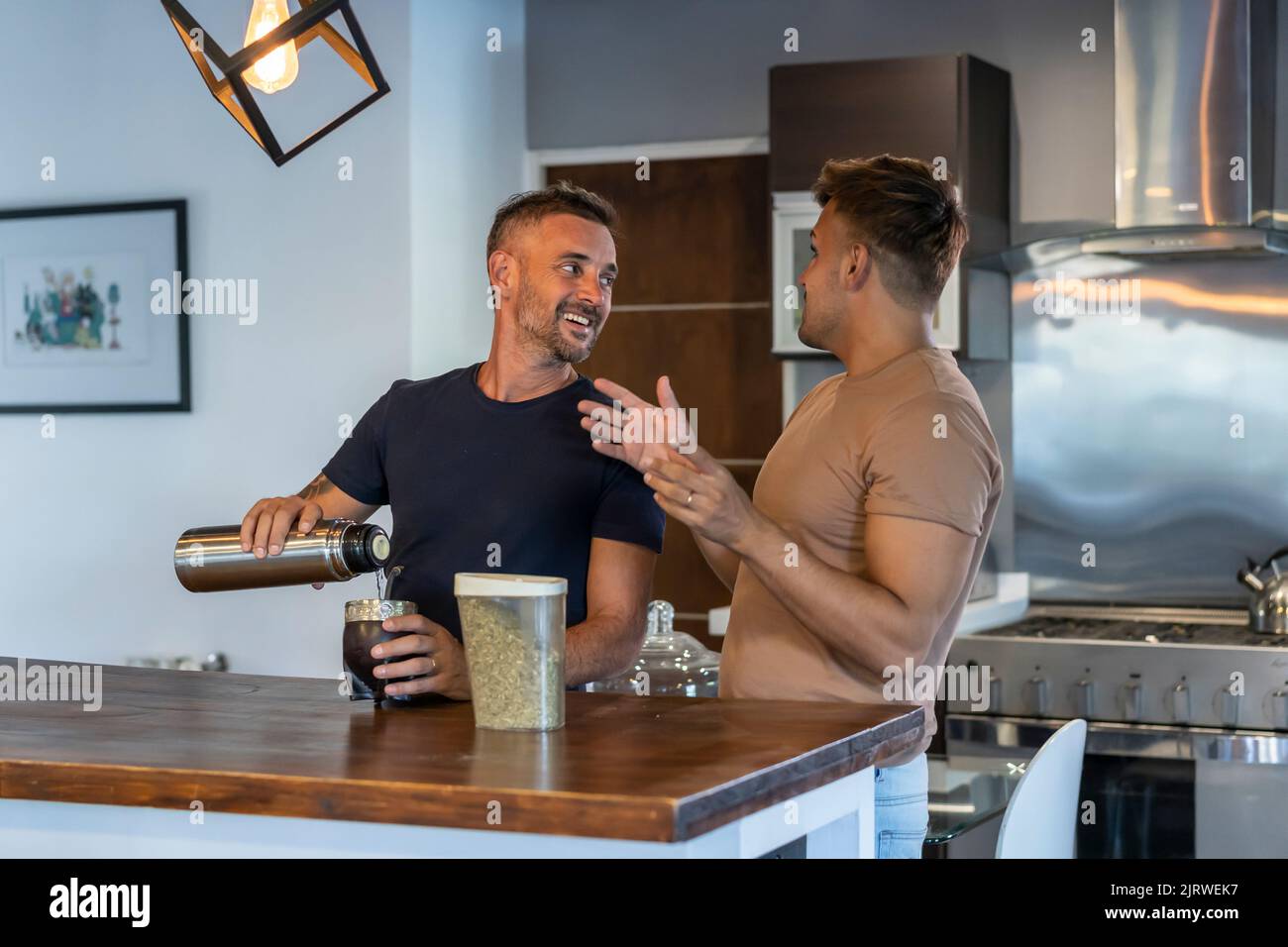 Young man talking while his husband prepares mate infusion Stock Photo ...