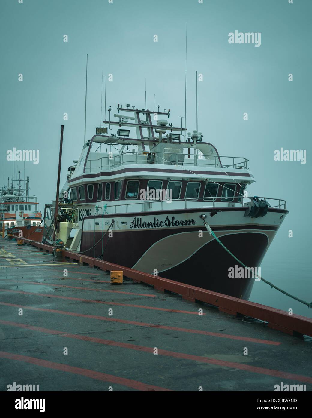 Boat docked at the harbor on a foggy night, St. Johns, Newfoundland and ...