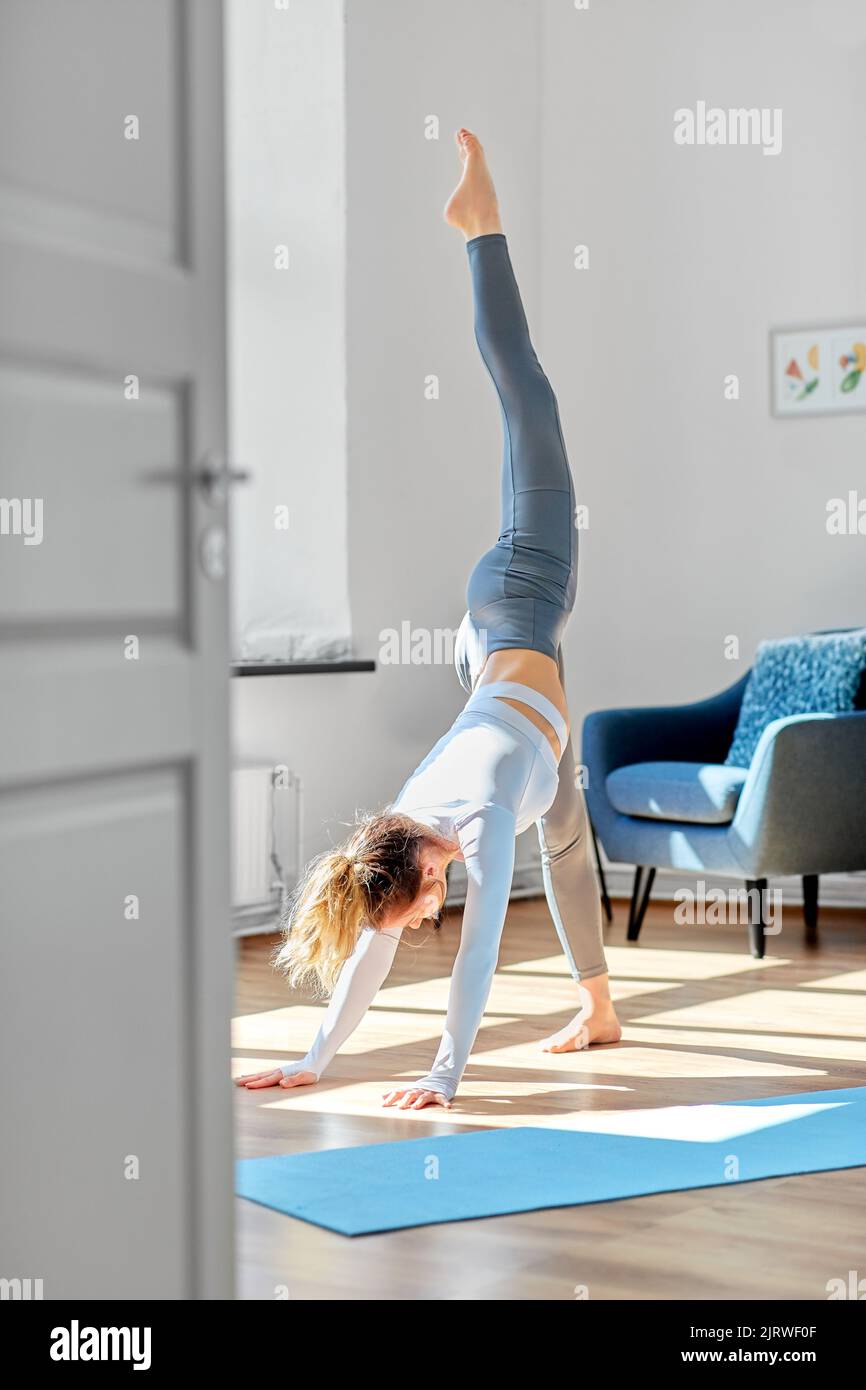 woman doing yoga exercise on window sill at studio Stock Photo - Alamy