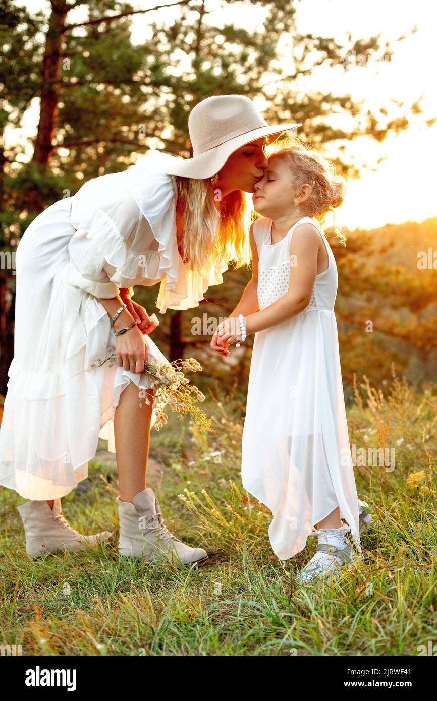 Side view of wonderful family standing in park forest illumined by ...